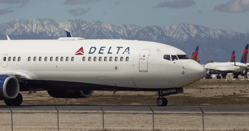 Image Source: Getty Images/ A Delta Air Lines jet taxis to be parked ...