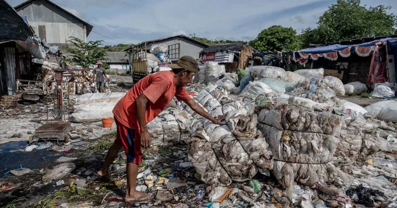 Cover Image Source: A worker collects the plastic waste for weighing ...